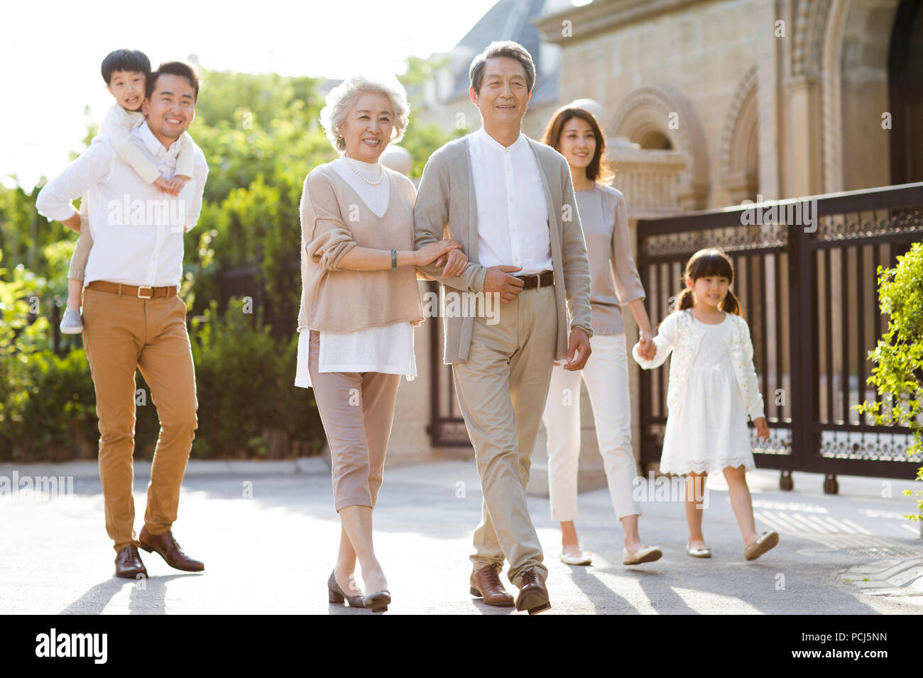 Happy Chinese family strolling outside Stock Photo - Alamy