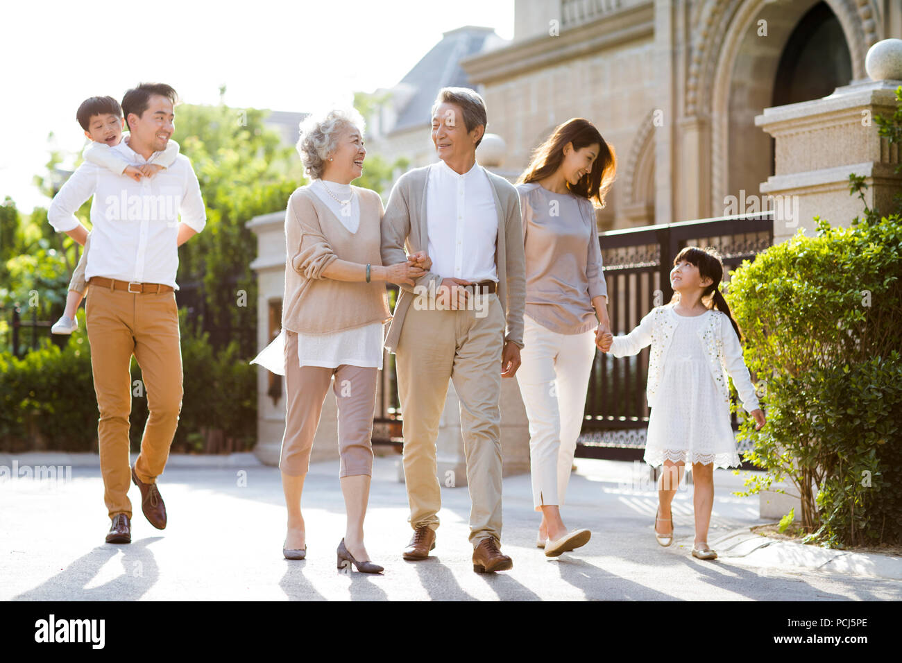 Happy Chinese family strolling outside Stock Photo - Alamy