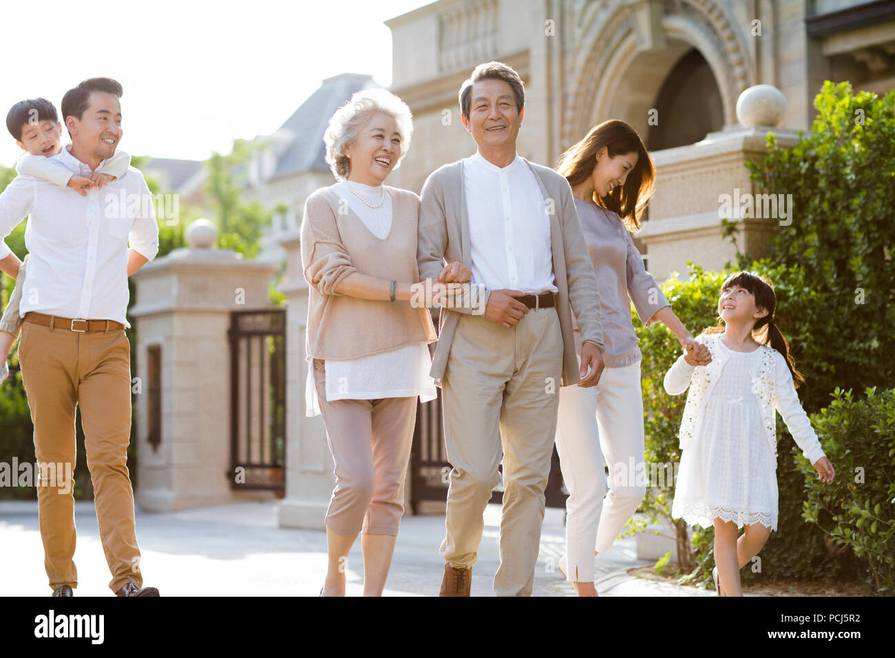 Happy Chinese family strolling outside Stock Photo - Alamy