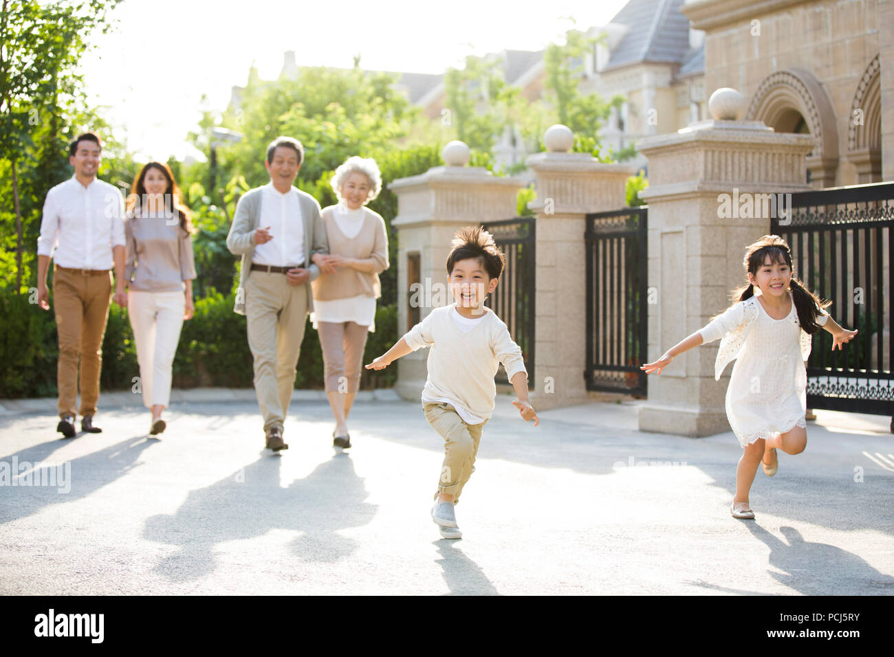 Happy Chinese family strolling outside Stock Photo - Alamy
