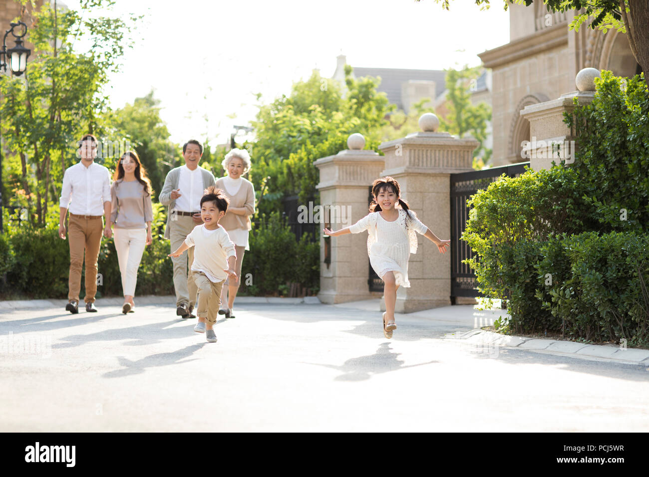 Happy Chinese family strolling outside Stock Photo - Alamy