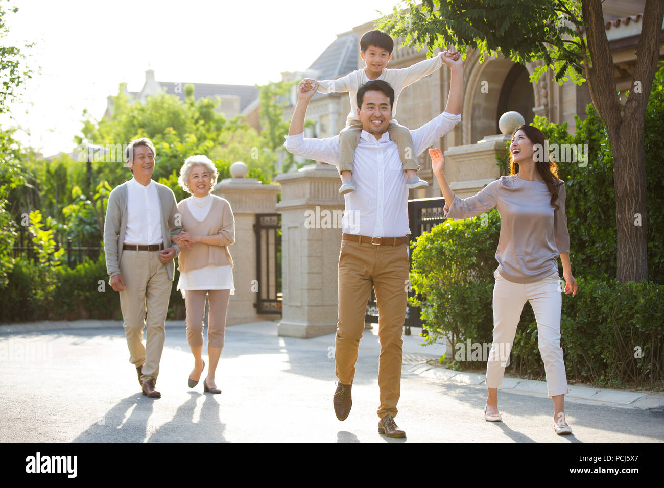 Happy Chinese family strolling outside Stock Photo - Alamy