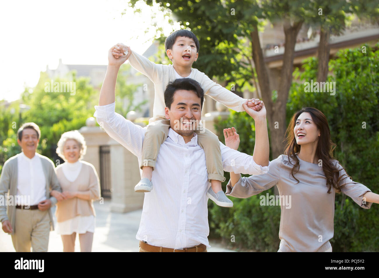 Happy Chinese family strolling outside Stock Photo - Alamy