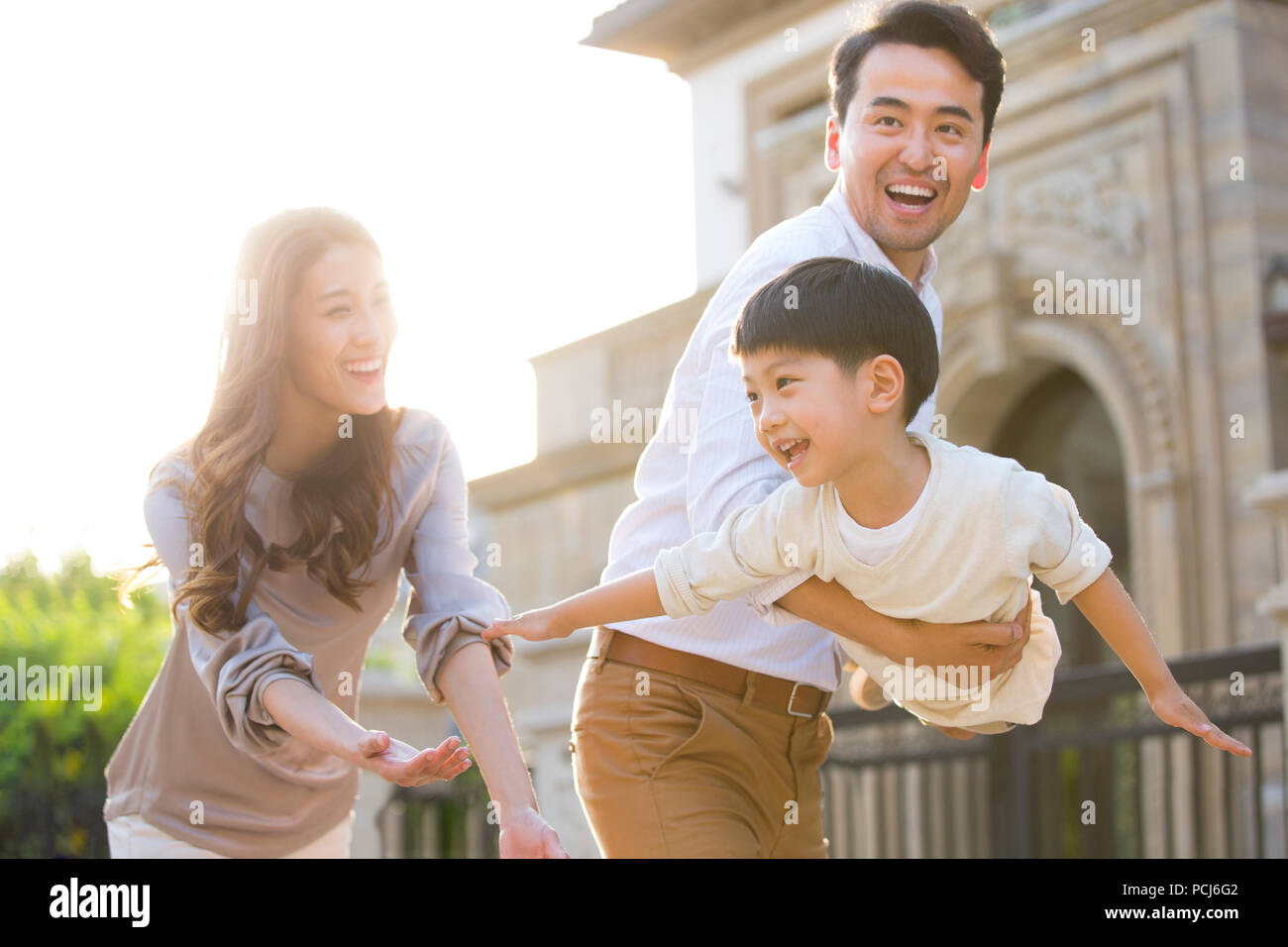 Happy young Chinese family playing outside Stock Photo - Alamy