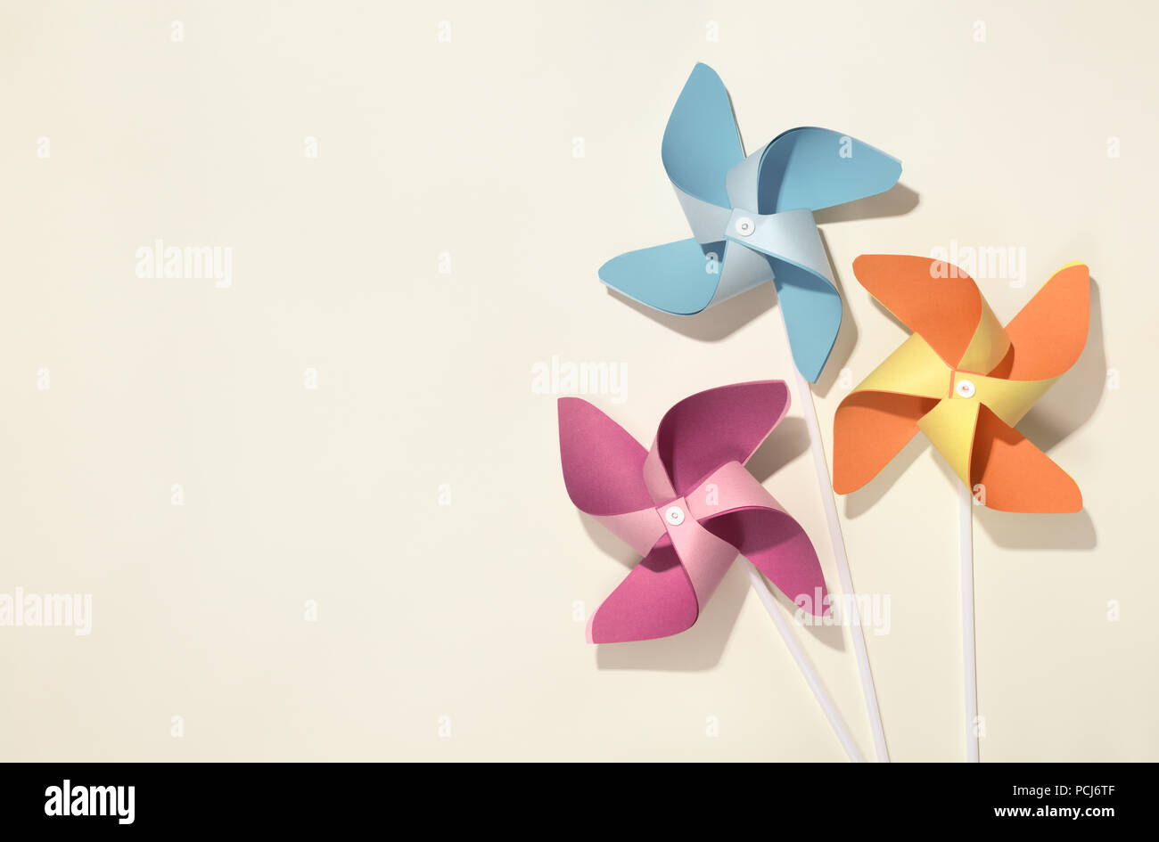 Colorful pinwheels on yellow background Stock Photo - Alamy