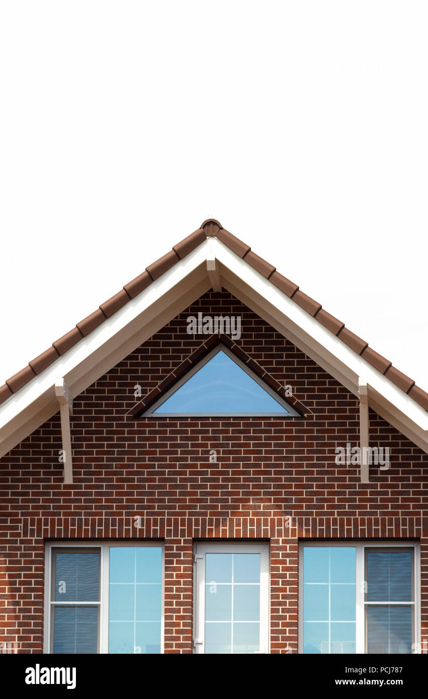 A large beautiful modern brick house close-up on a white background ...