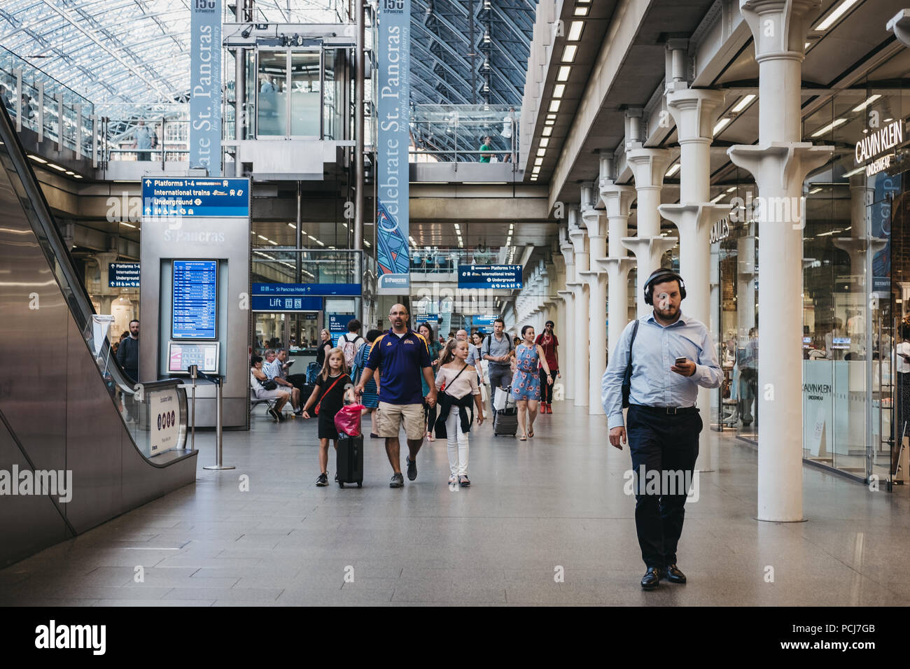 People walking inside St. Pancras Station, front view. St. Pancras is ...