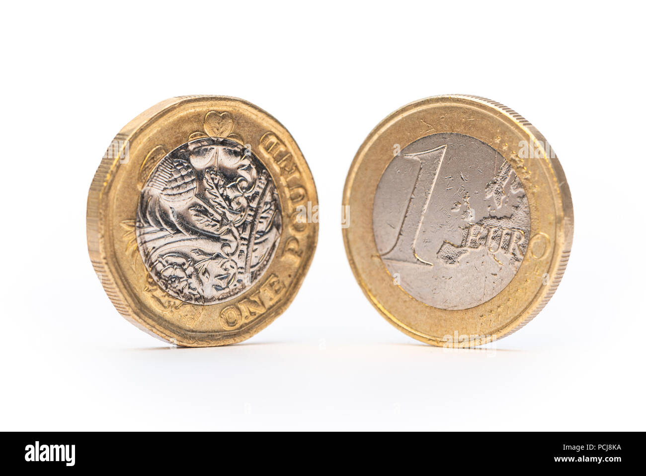 Euro coin and new pound coin isolated on white background Stock Photo ...