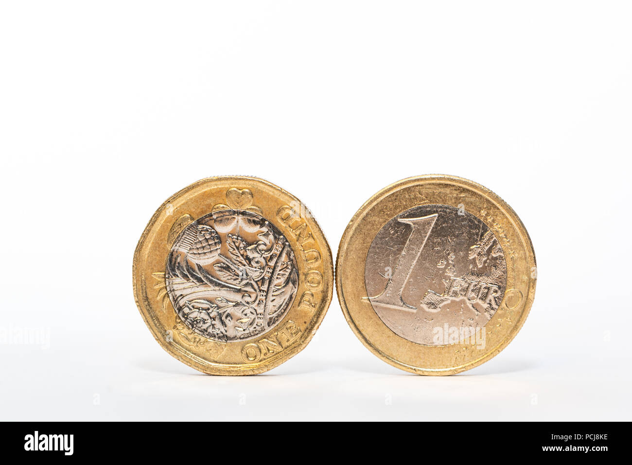 Euro coin and new pound coin isolated on white background Stock Photo ...