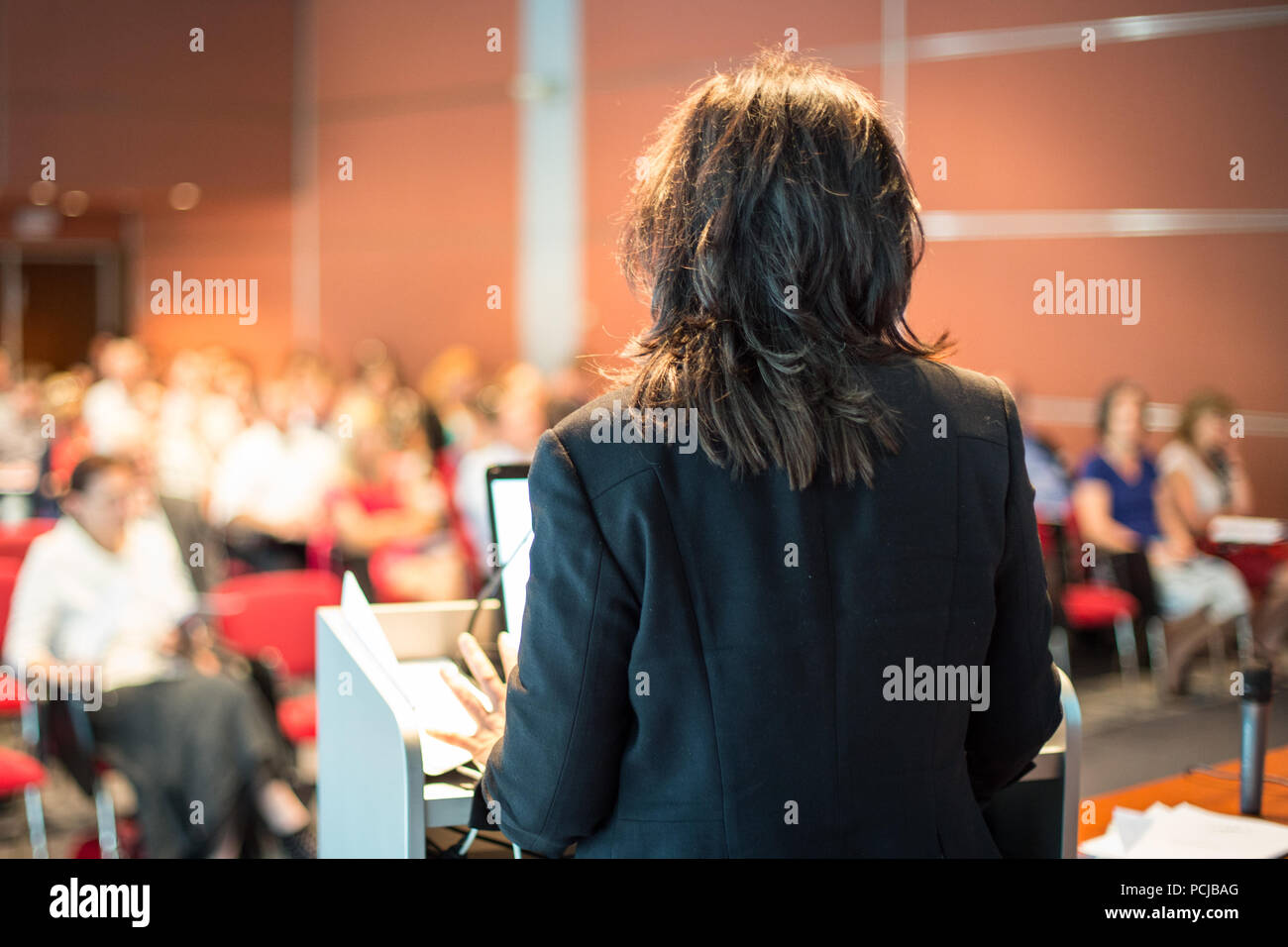 Female public speaker giving talk at Business Event Stock Photo - Alamy