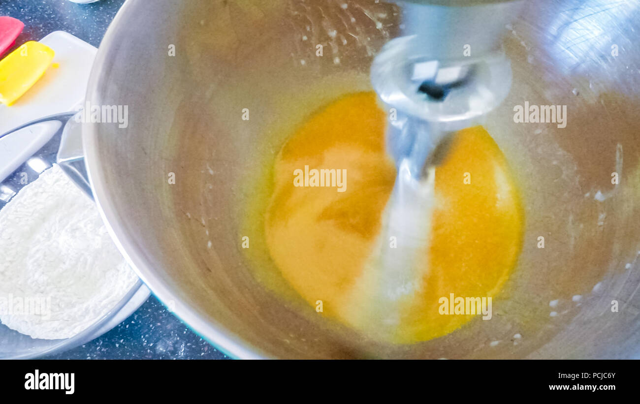 Step by step. Mixing ingredients in kitchen mixer to make vanilla ...