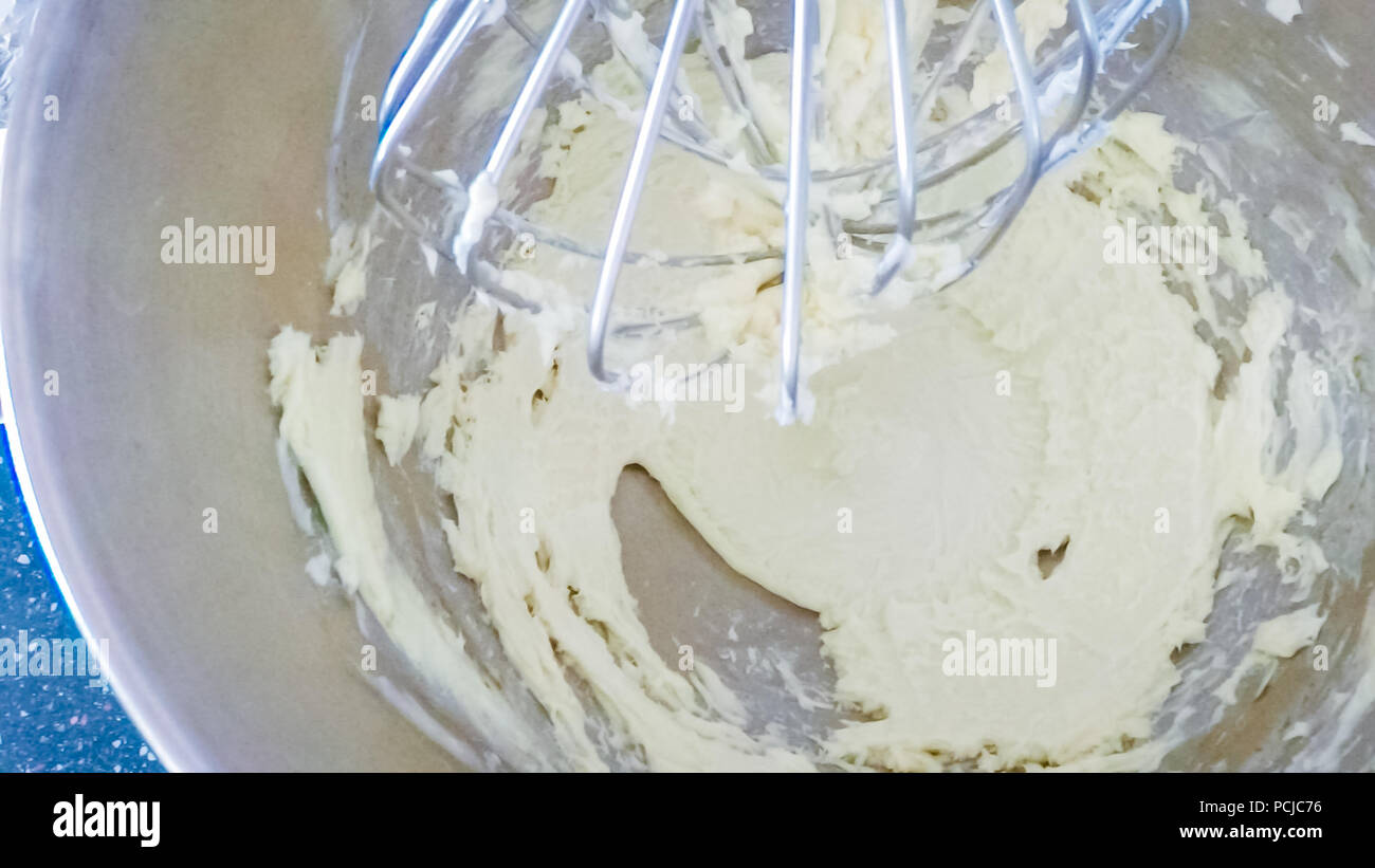Step by step. Mixing ingredients in kitchen mixer to make vanilla ...