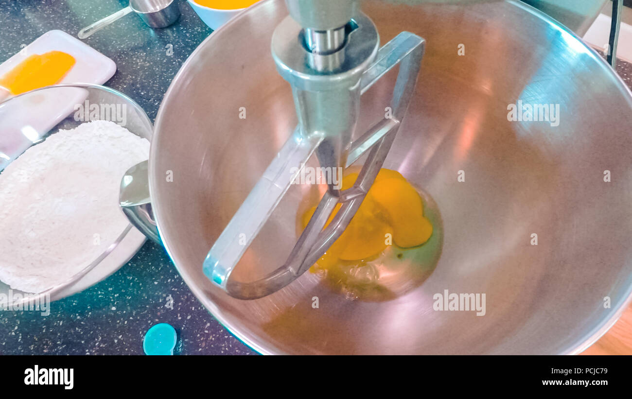 Step by step. Mixing ingredients in kitchen mixer to make vanilla ...