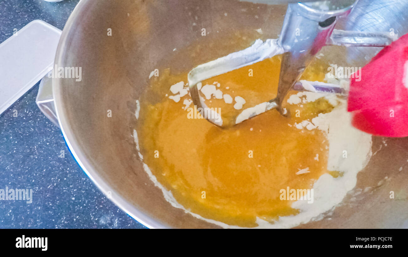 Step by step. Mixing ingredients in kitchen mixer to make vanilla ...