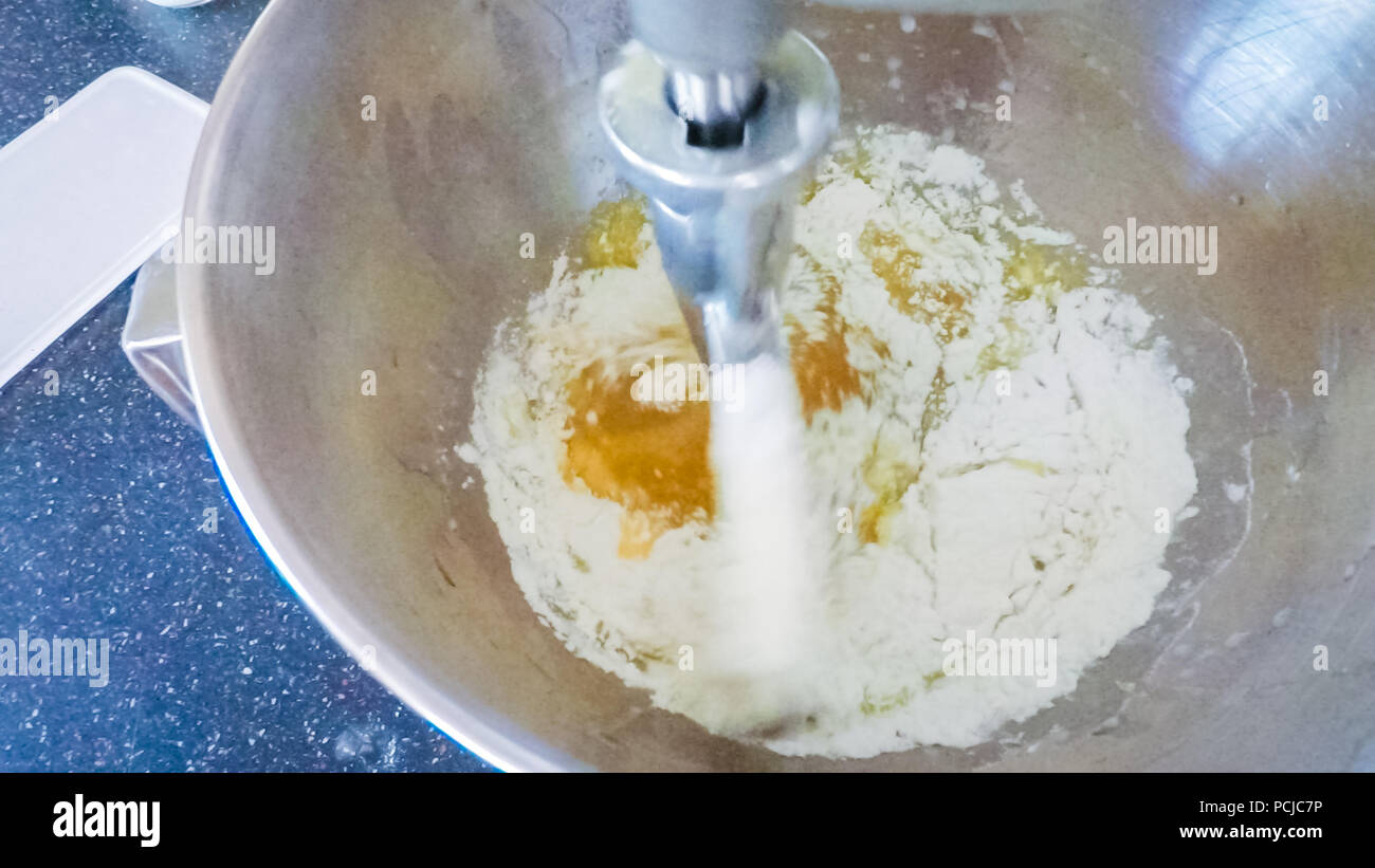 Step by step. Mixing ingredients in kitchen mixer to make vanilla ...