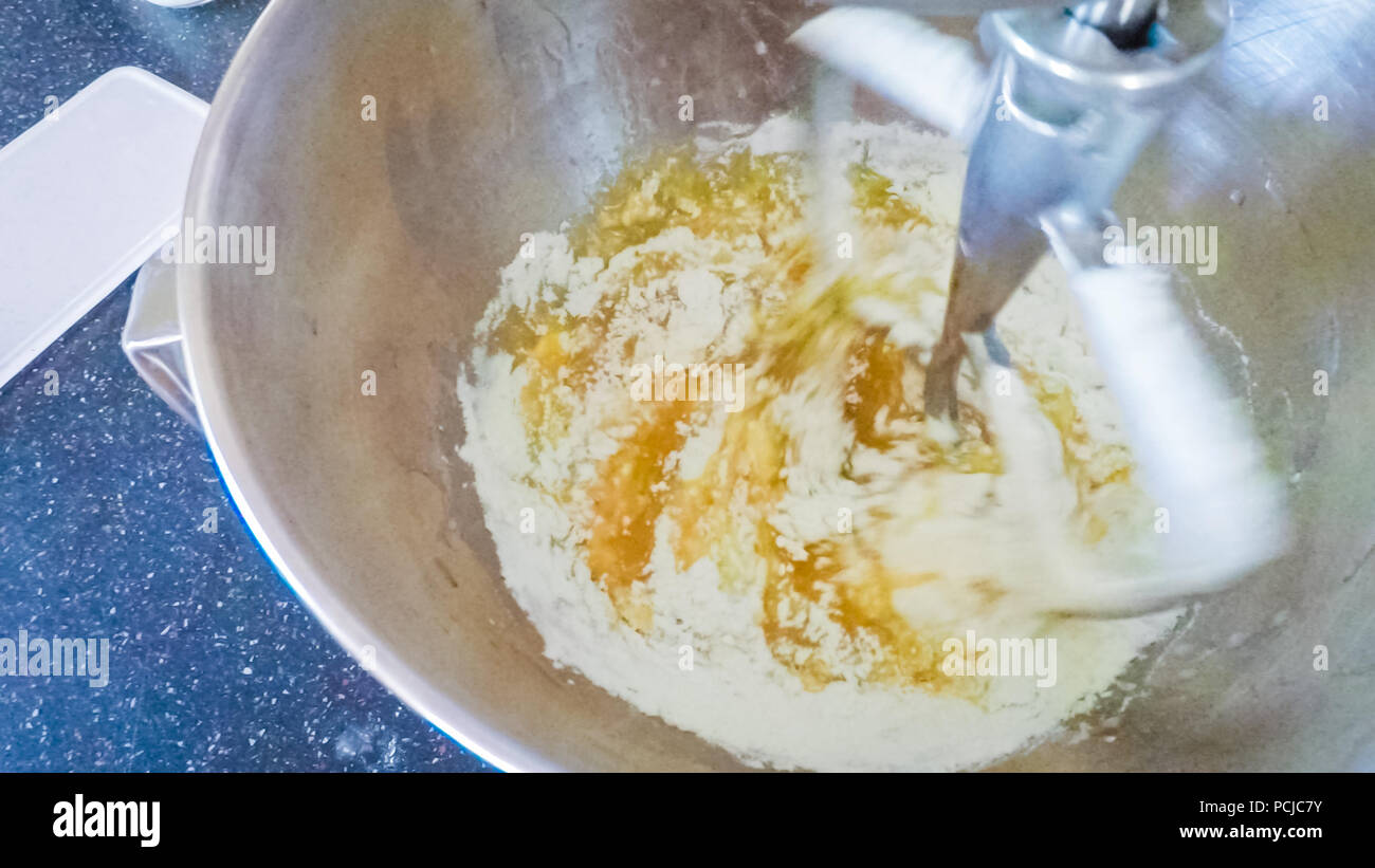 Step by step. Mixing ingredients in kitchen mixer to make vanilla ...