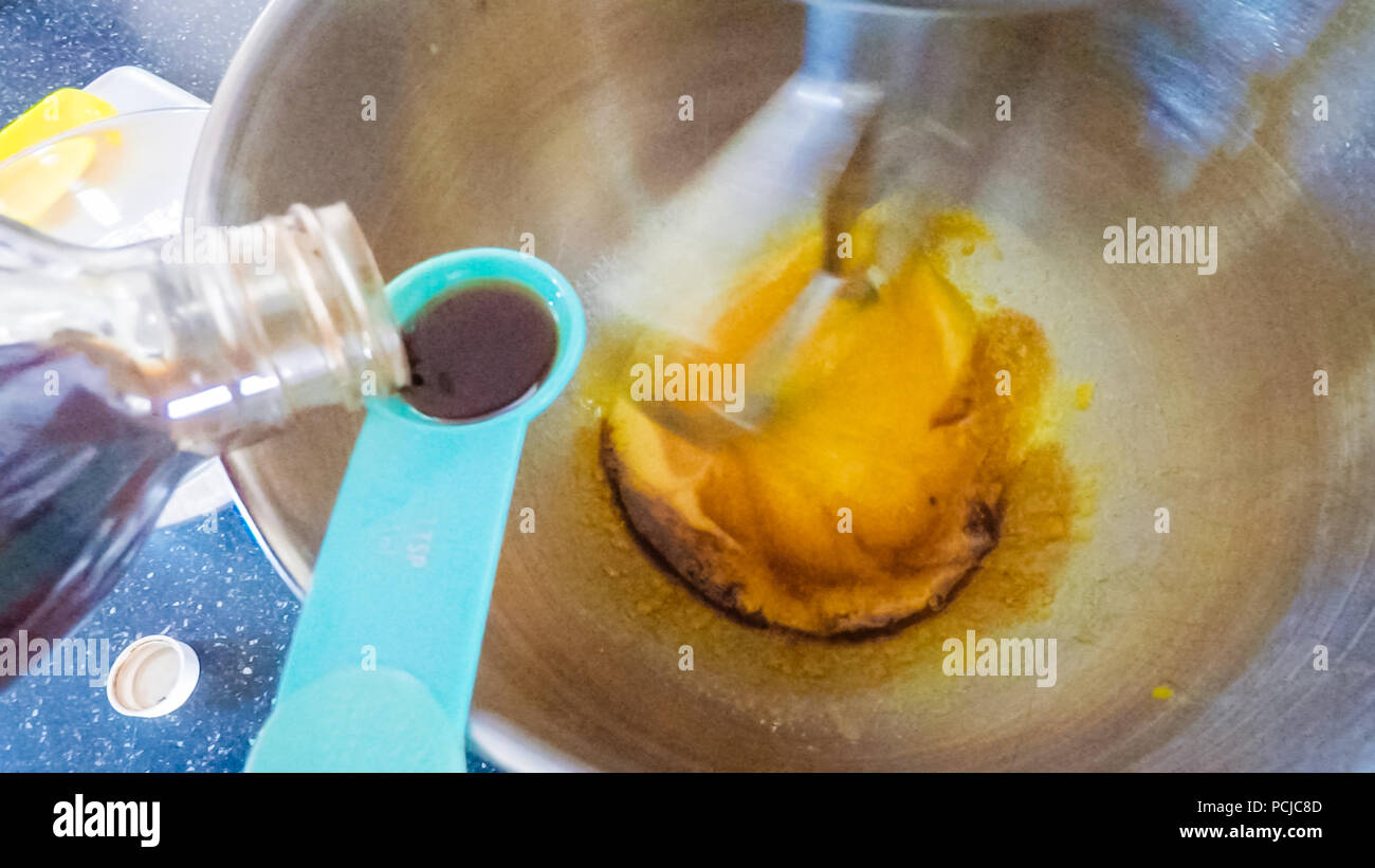 Step by step. Mixing ingredients in kitchen mixer to make vanilla ...