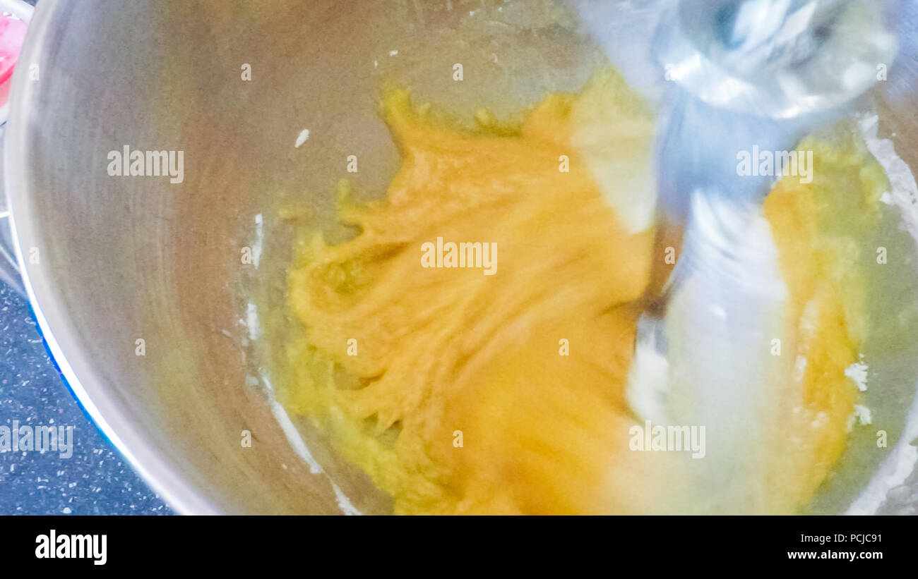 Step by step. Mixing ingredients in kitchen mixer to make vanilla ...