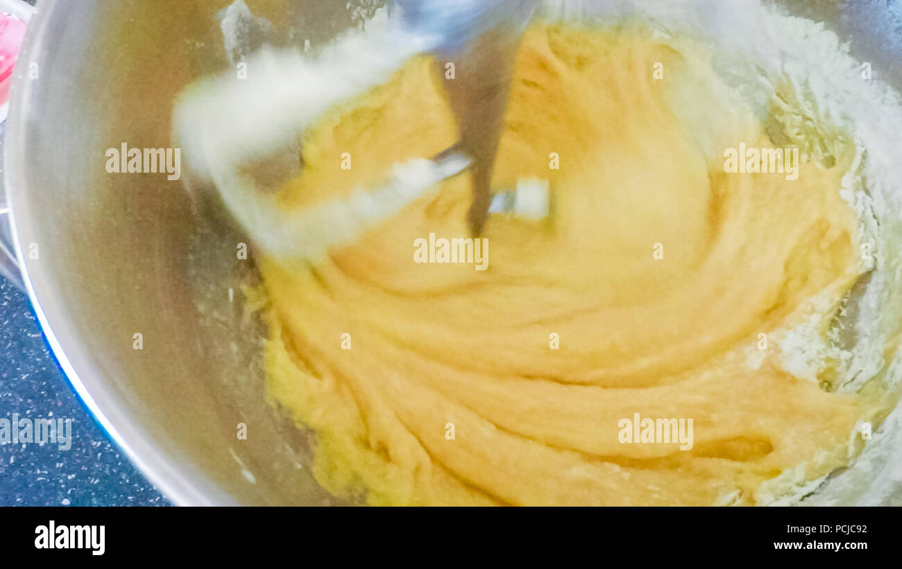 Step by step. Mixing ingredients in kitchen mixer to make vanilla ...