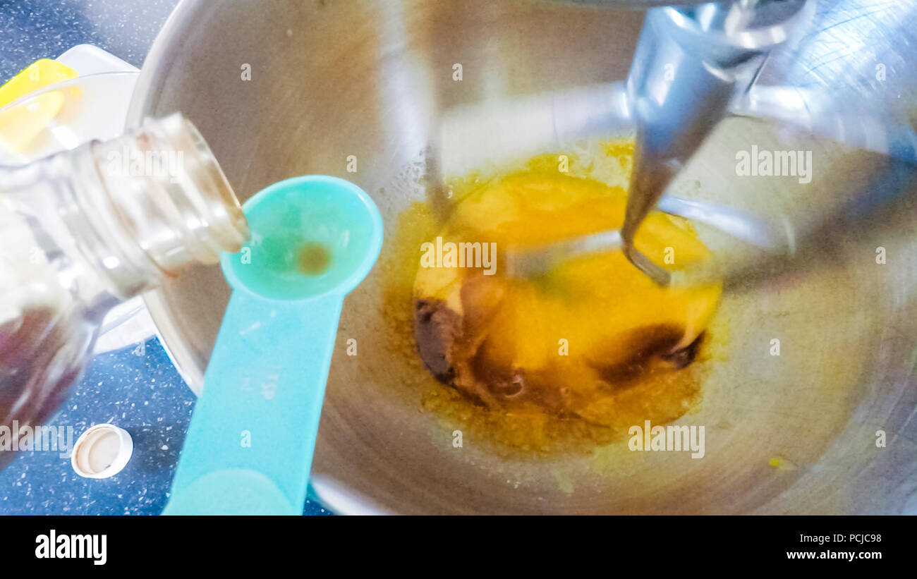 Step by step. Mixing ingredients in kitchen mixer to make vanilla ...