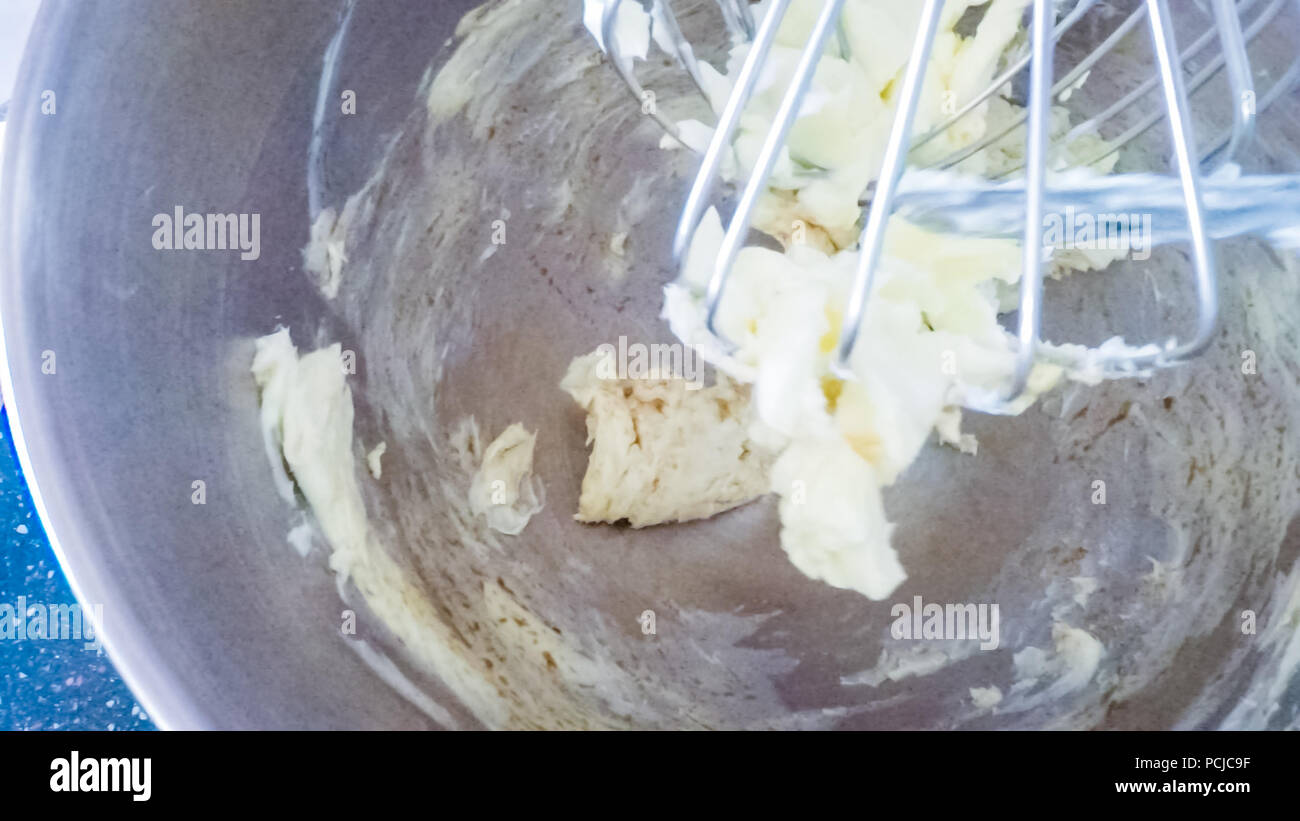 Step by step. Mixing ingredients in kitchen mixer to make vanilla ...