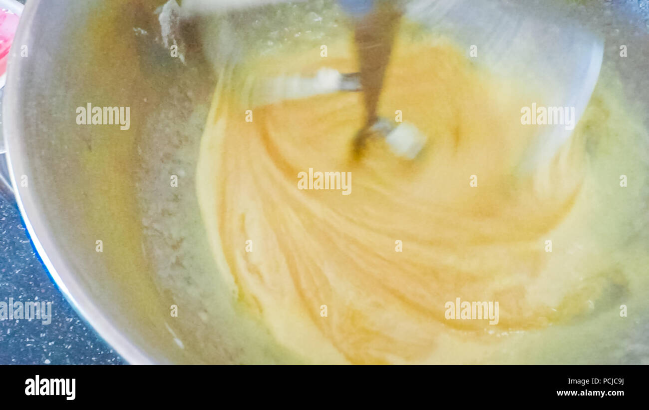 Step by step. Mixing ingredients in kitchen mixer to make vanilla ...