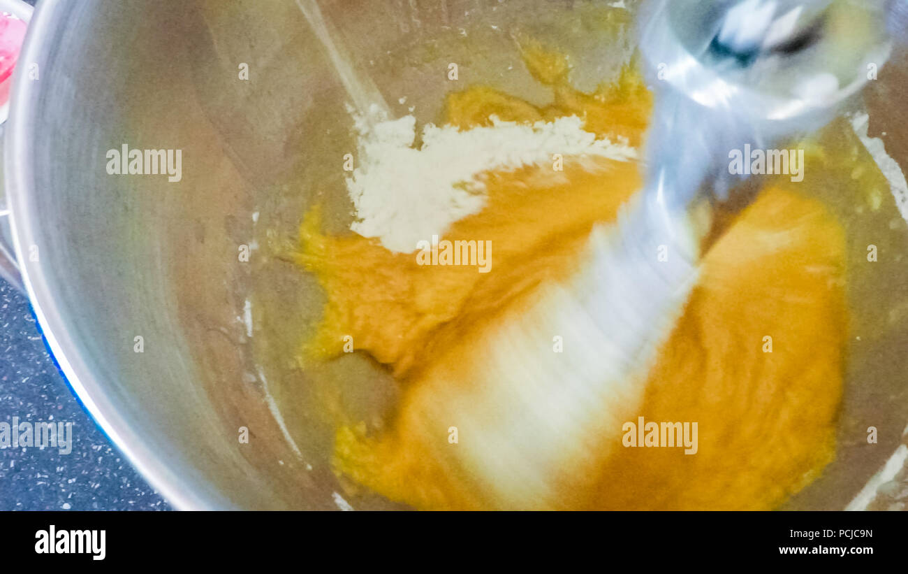 Step by step. Mixing ingredients in kitchen mixer to make vanilla ...