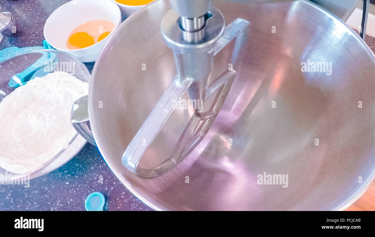 Step by step. Mixing ingredients in kitchen mixer to make vanilla ...
