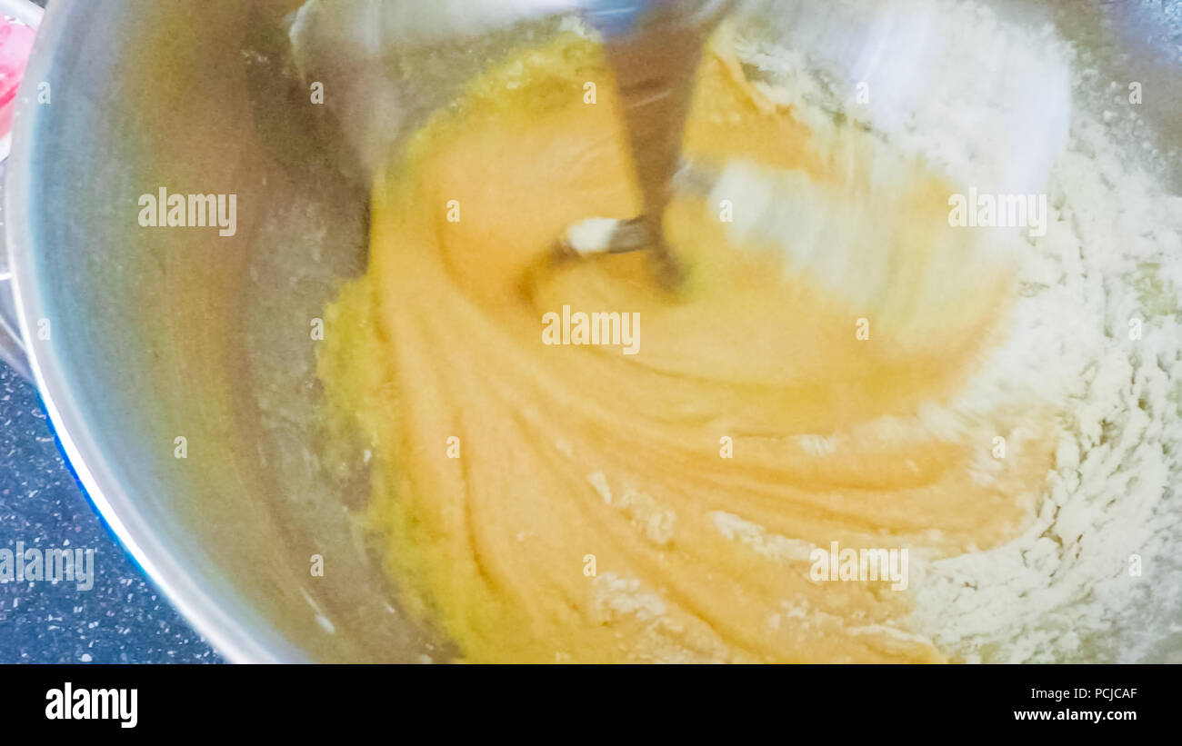 Step by step. Mixing ingredients in kitchen mixer to make vanilla ...