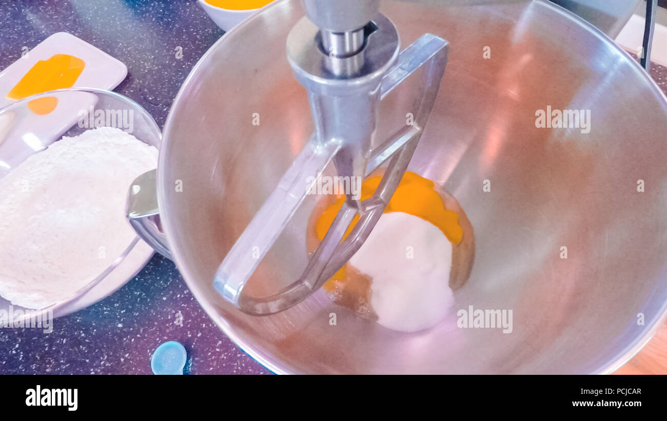 Step by step. Mixing ingredients in kitchen mixer to make vanilla ...
