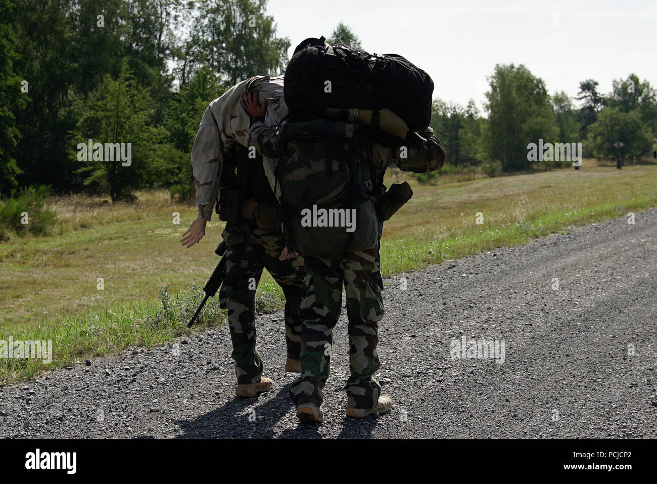 A French sniper team carries a simulated causality during the stress ...
