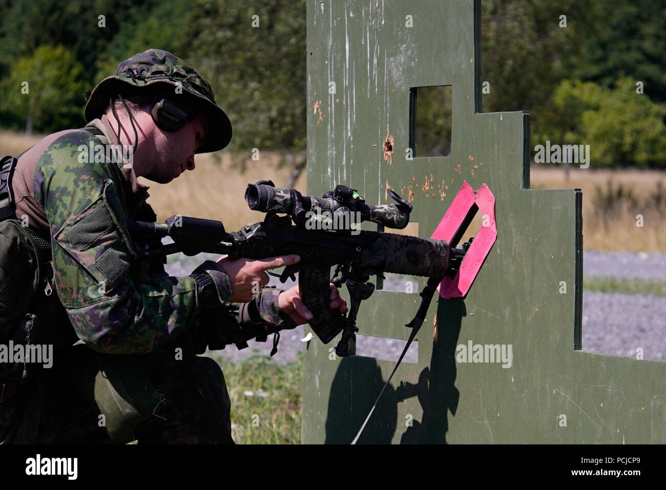 A Finnish sniper reloads a magazine before engaging targets during the ...