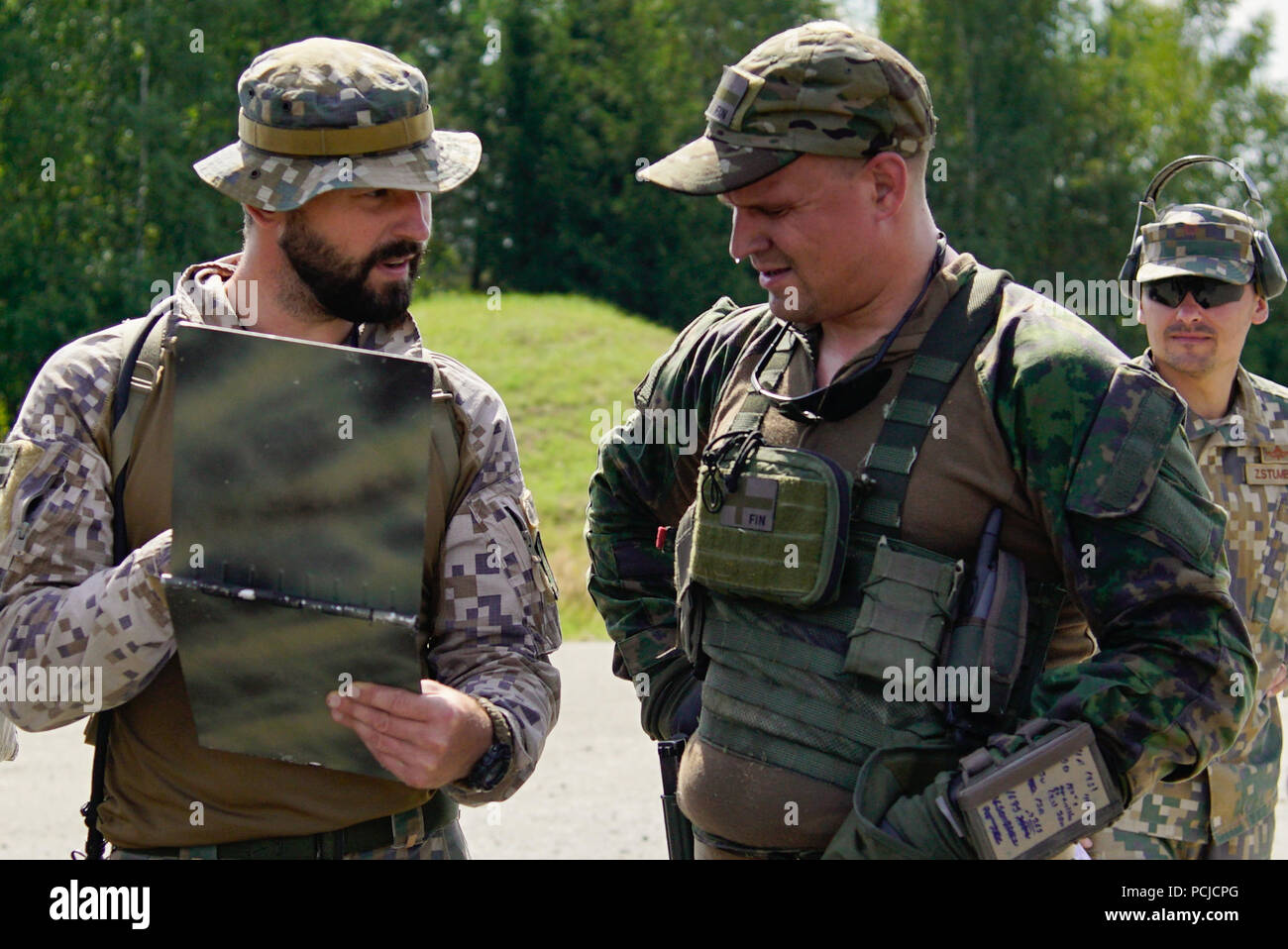 A Latvian soldier, left, reviews scores with a Finnish sniper after the ...