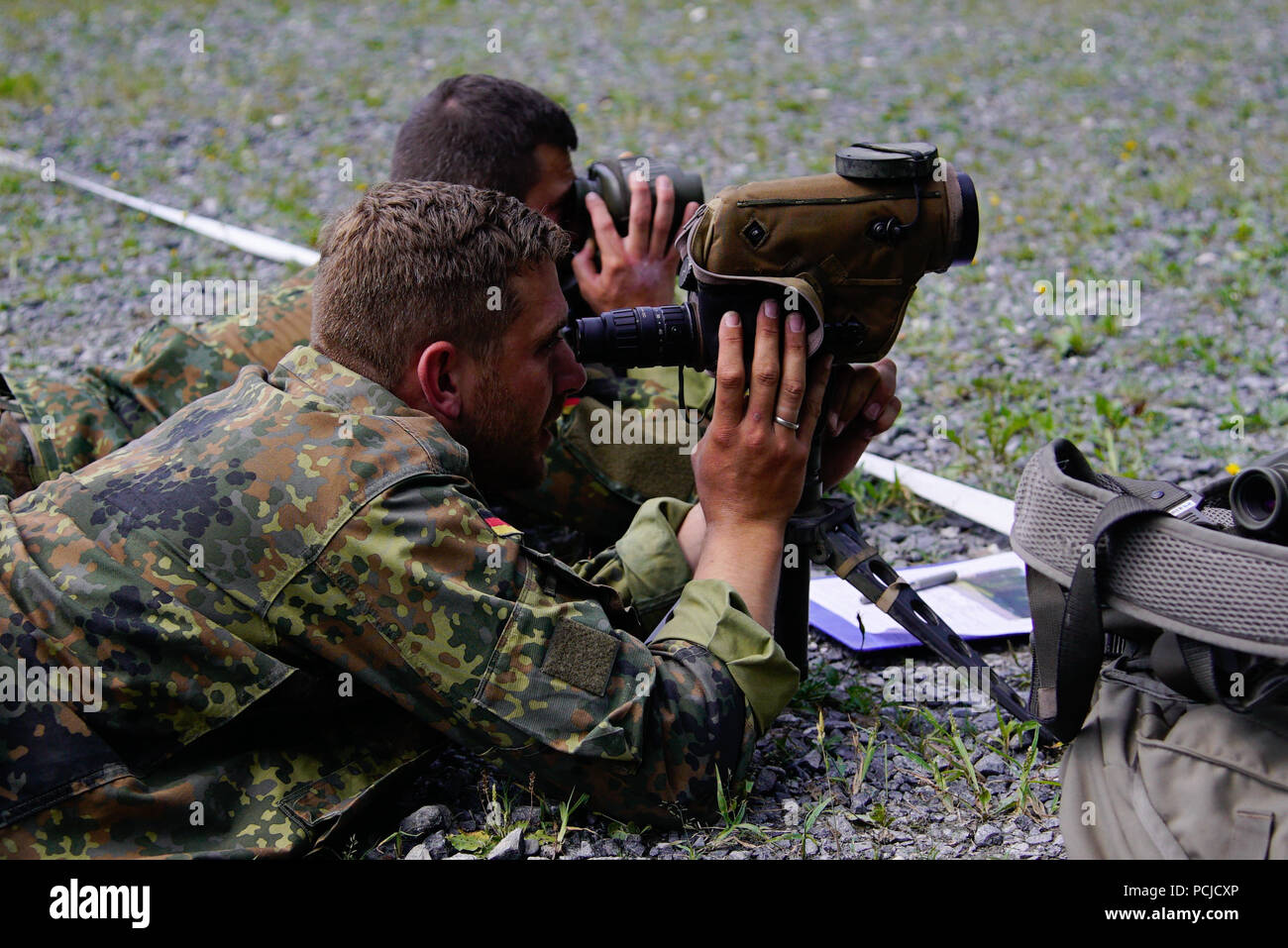 A German sniper team identifies targets during the range estimation ...
