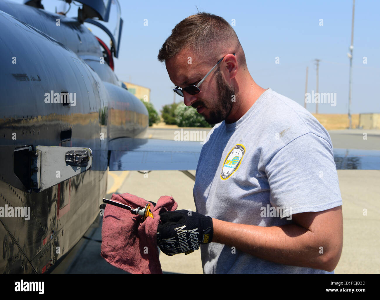 Jesse Mace, T-38 aircraft mechanic, checks the oil in a T-38 Talon ...