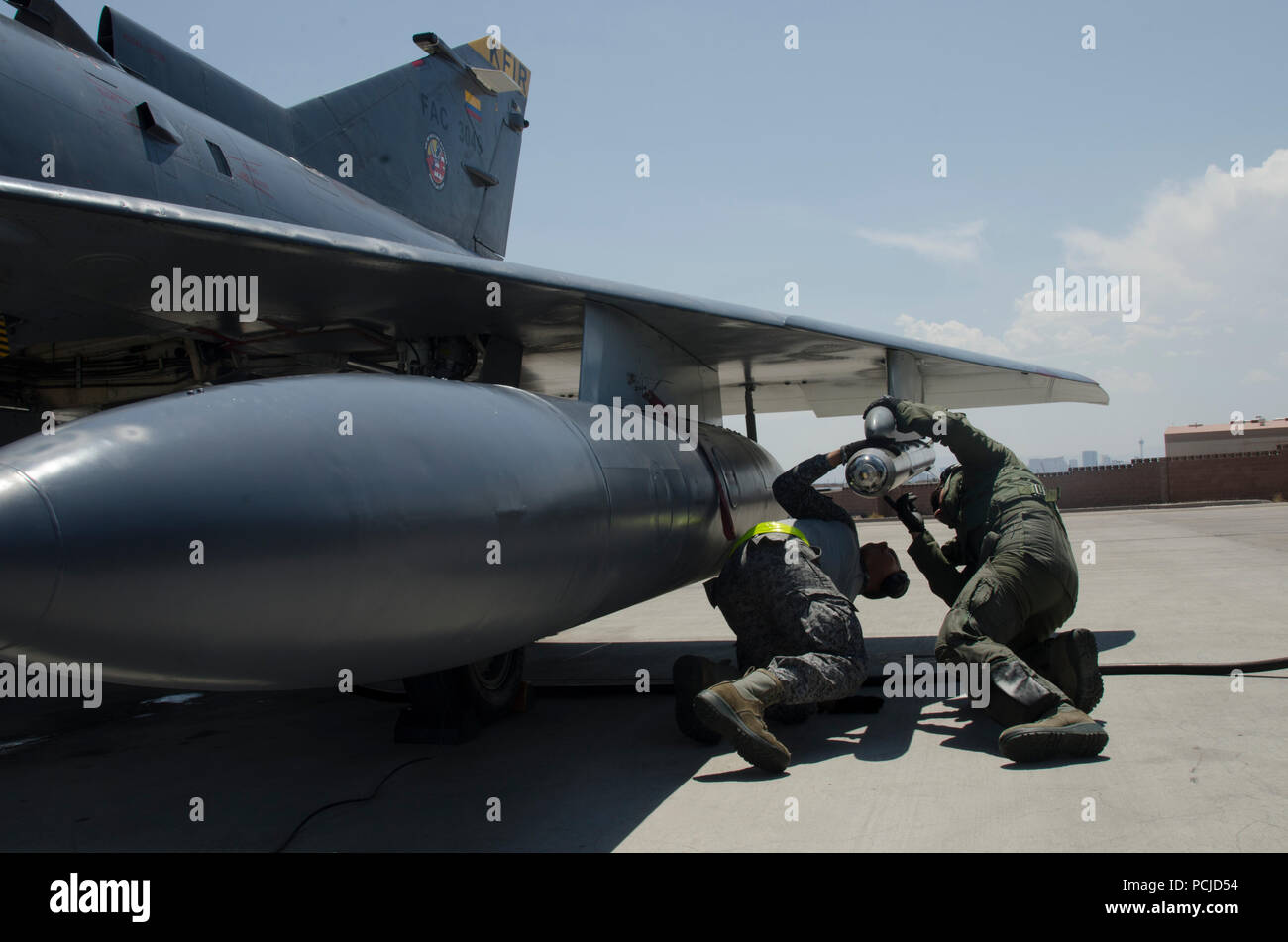 A Colombian Air Force Kfir fighter jet pilot and crew chief conduct pre ...