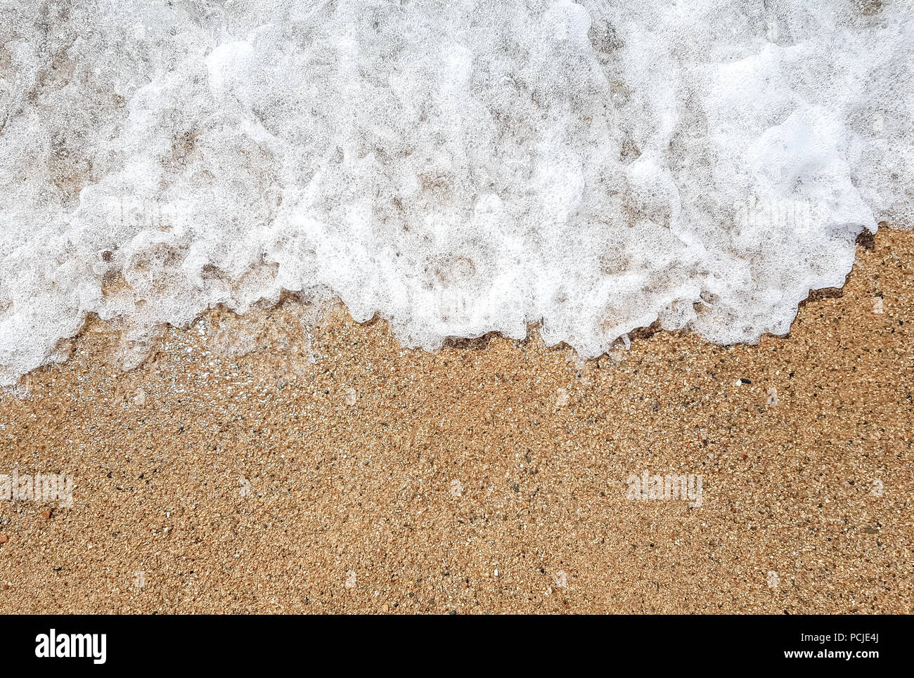 Ocean wave on sandy beach Stock Photo - Alamy