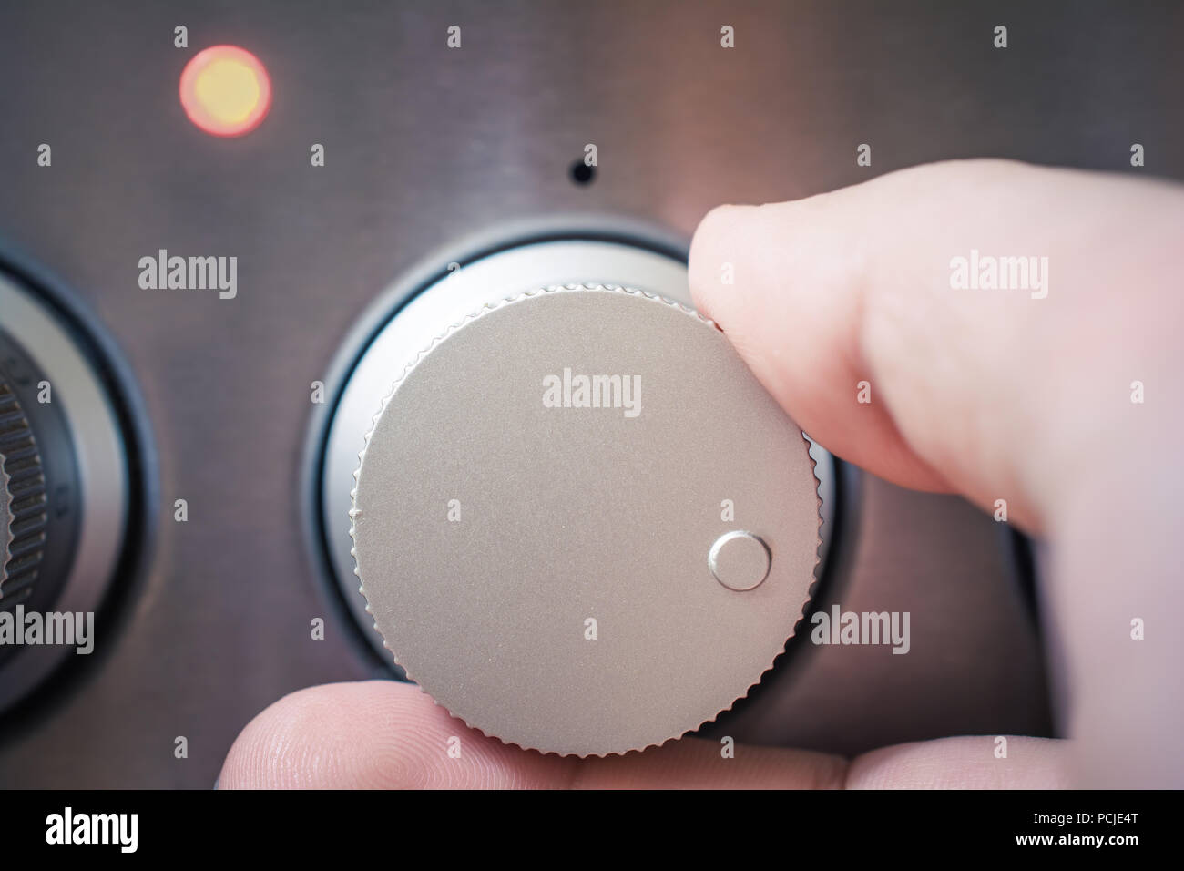 Front View Of A Male Hand Using Oven Controls, Oven And The Control ...