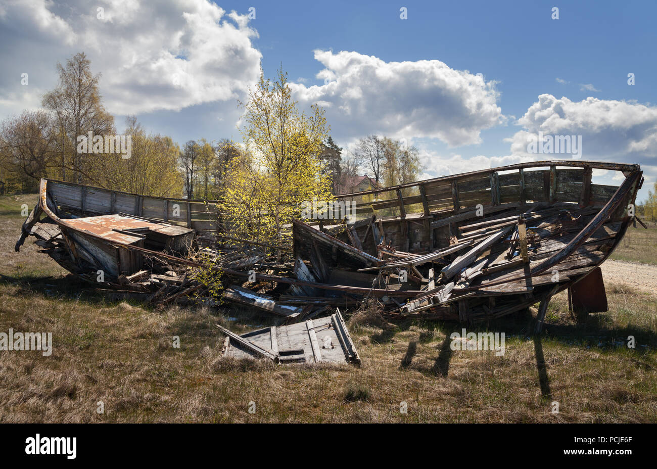 Old and broken wooden boat on a grass Stock Photo - Alamy