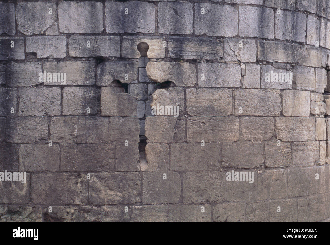 Defensive slit in the medieval wall around York, England. Photograph ...