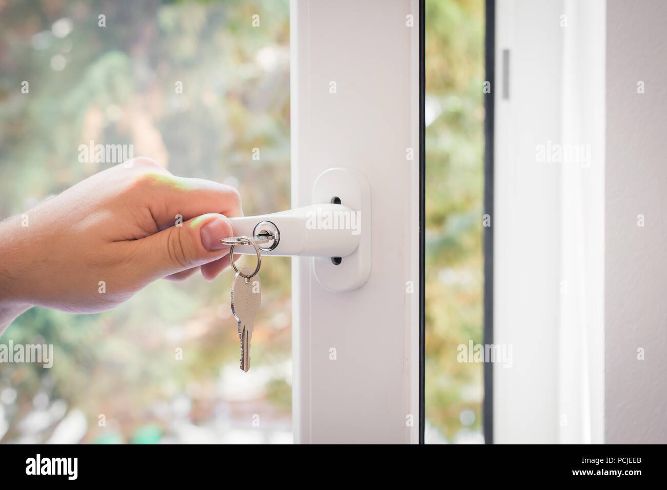 Window With A Lockable Handle And Keys Closed By A Male Hand ...