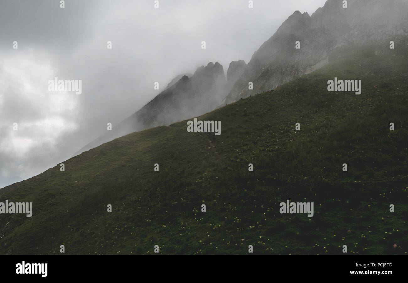 scary hiking path in the fog on steep mountain. hiking path through ...