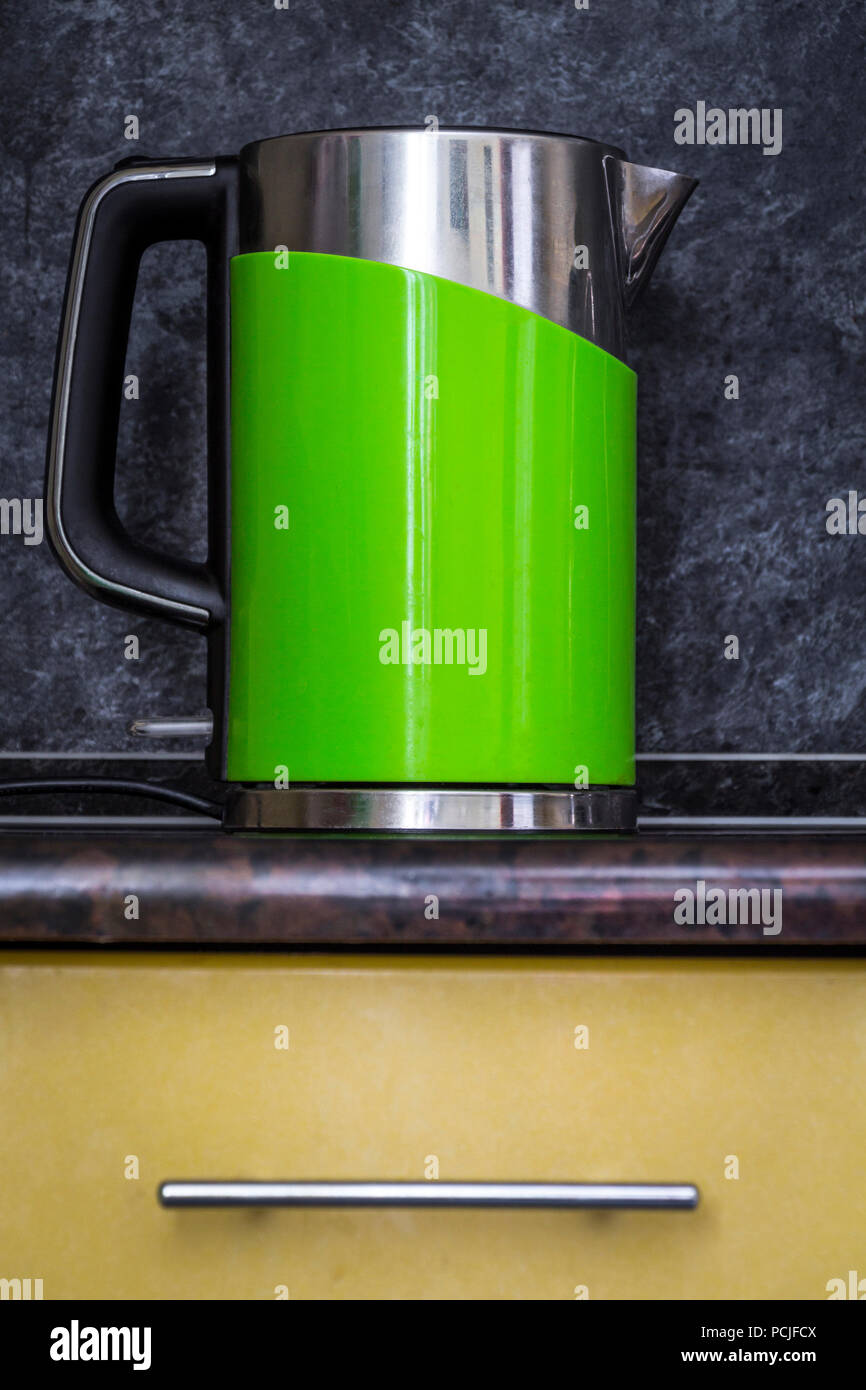 A green electric kettle stands on the kitchen table close-up Stock ...