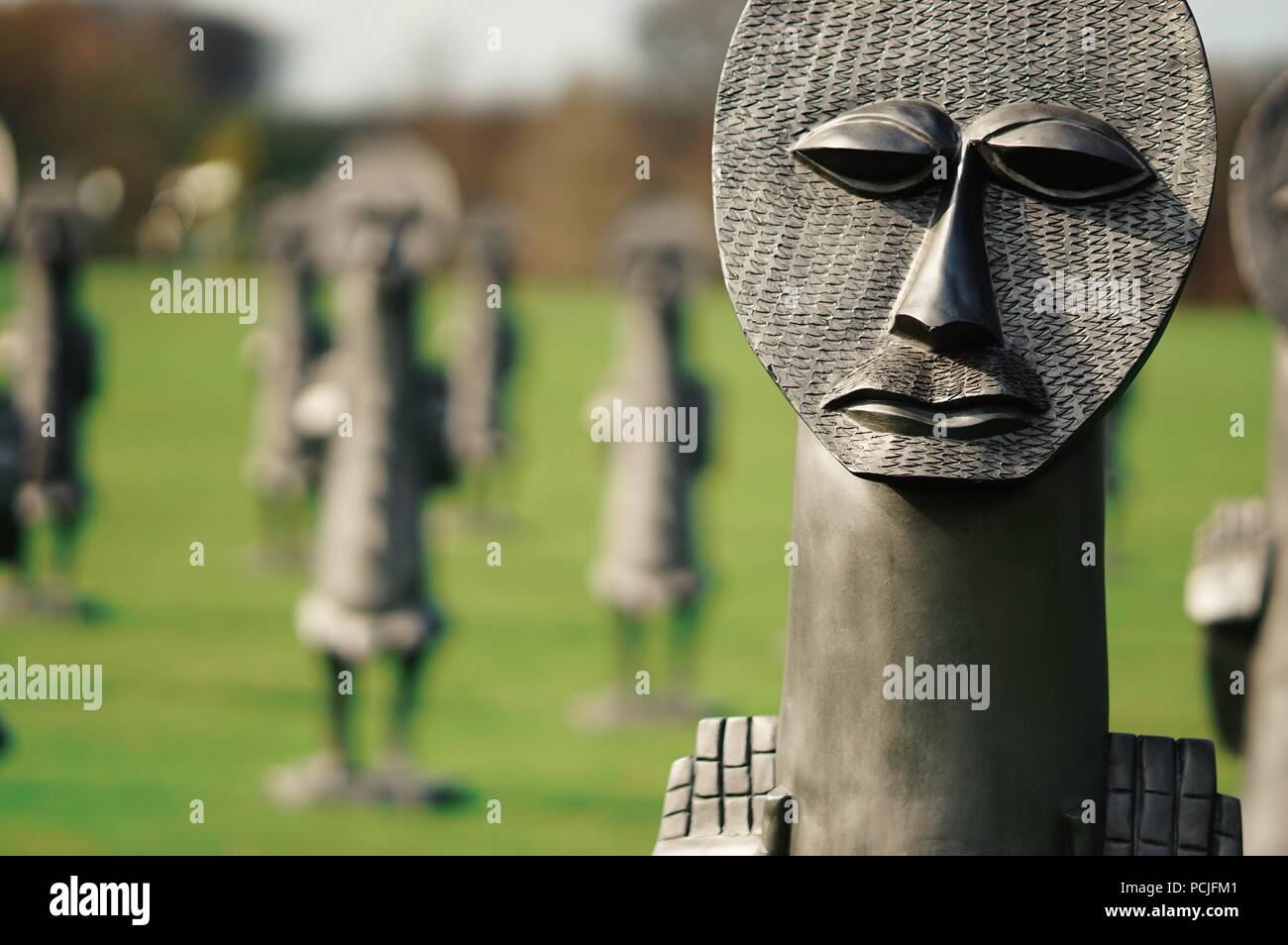Statue or sculpture of weird faces in a garden, photo taken in ...