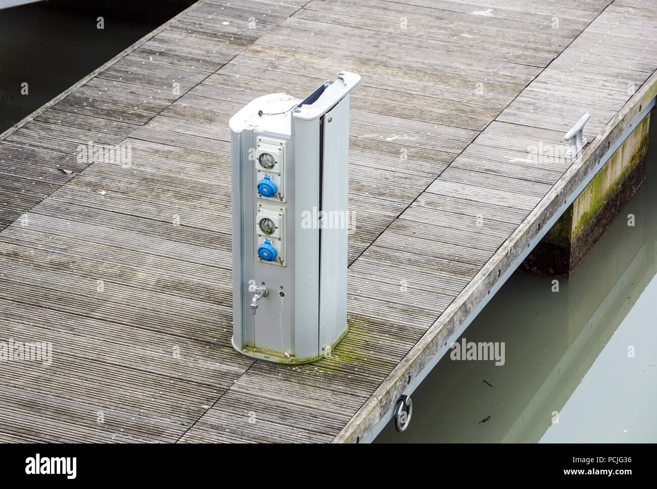 Electricity and water station in yacht harbor Stock Photo - Alamy