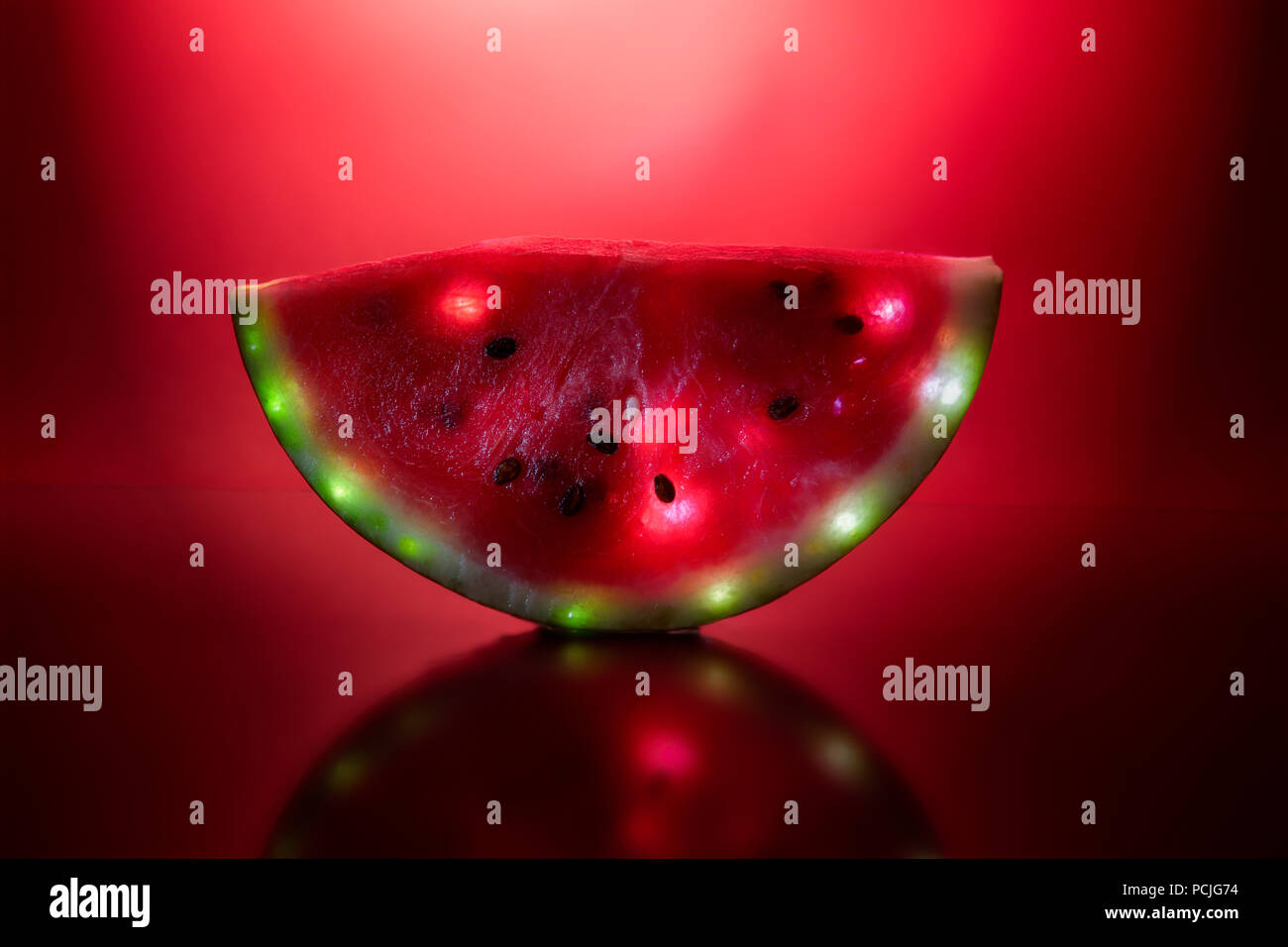 Slice of watermelon illuminated with LED lights Stock Photo - Alamy