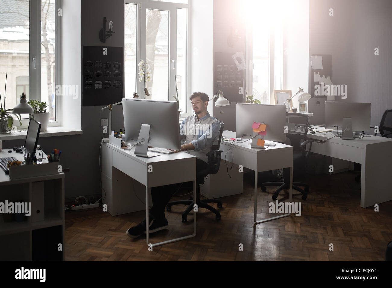 A man working in a modern design office Stock Photo - Alamy