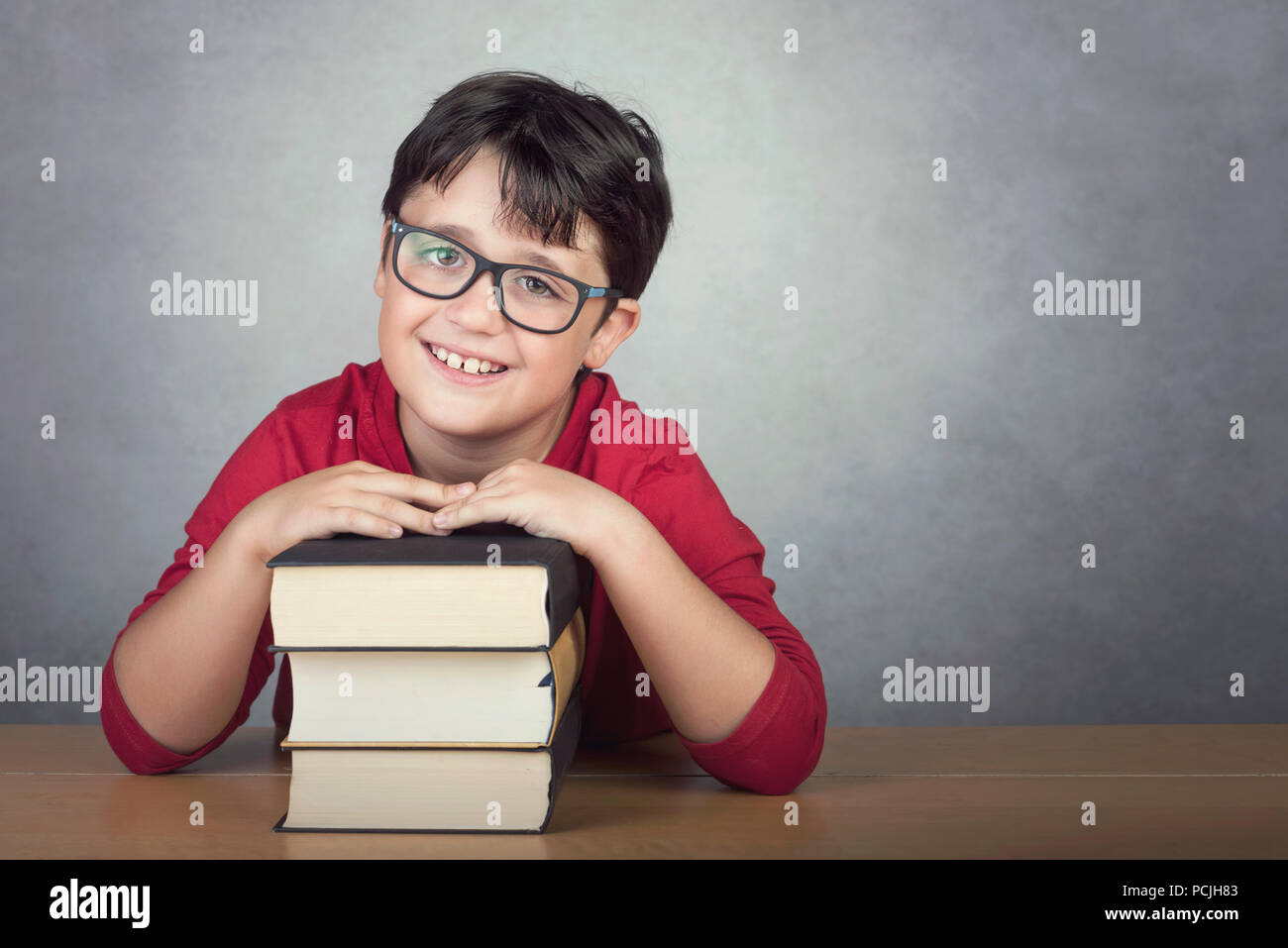 Boy leaning on books hi-res stock photography and images - Alamy