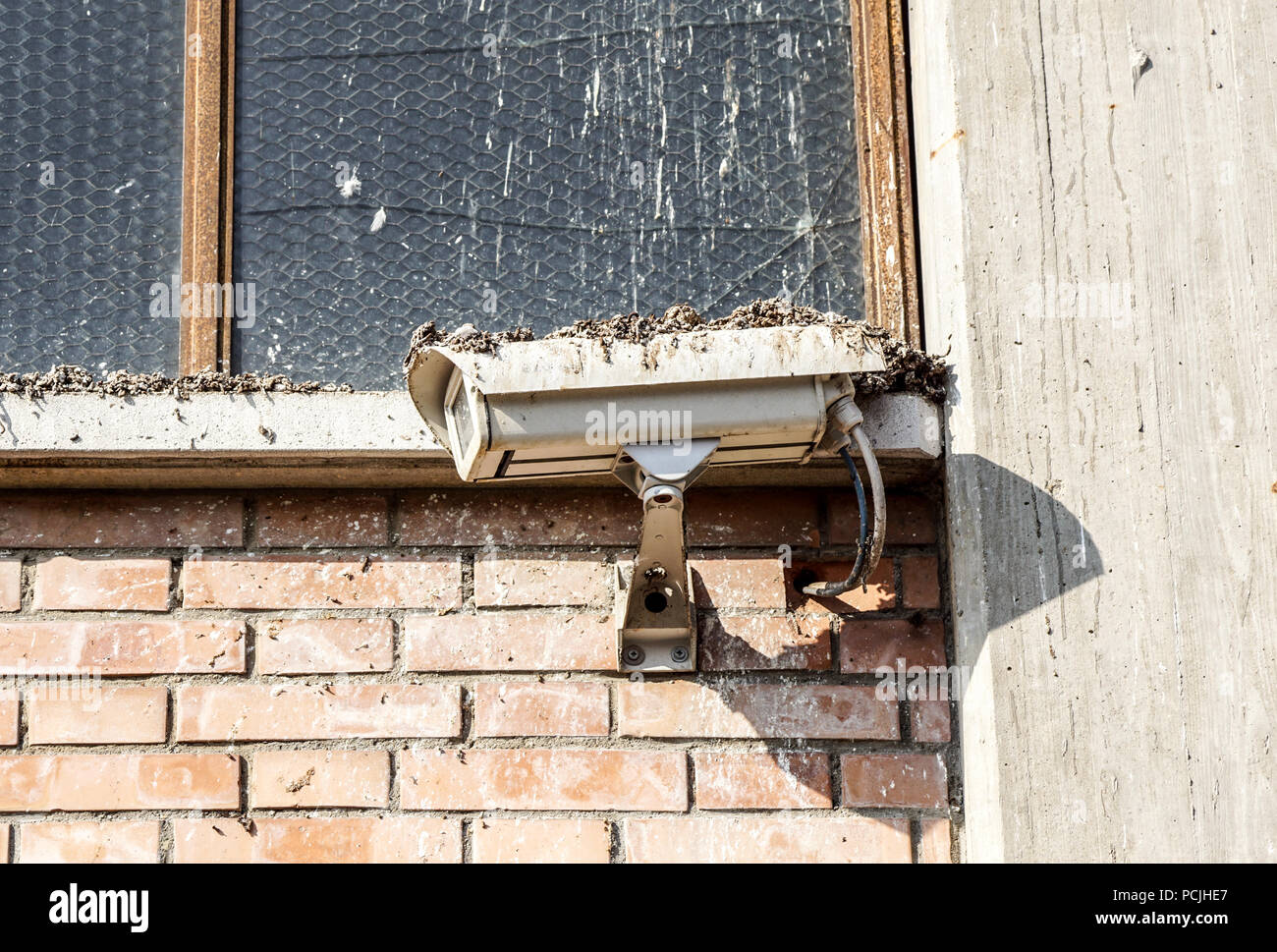 Old dirty Security camera on industrial building Stock Photo - Alamy