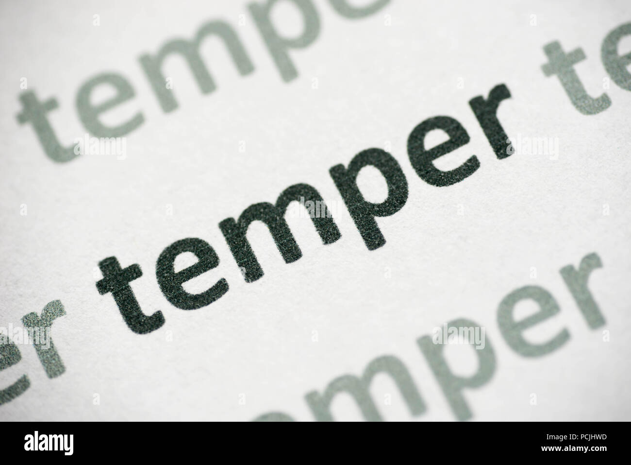 word temper printed on white paper macro Stock Photo - Alamy